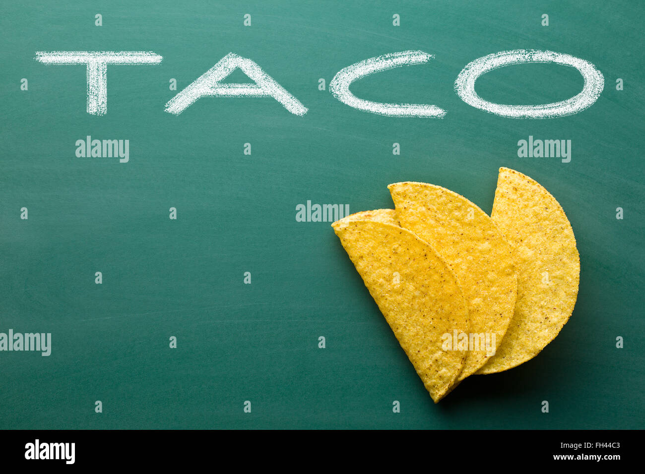 crispy taco shells on green chalkboard Stock Photo - Alamy