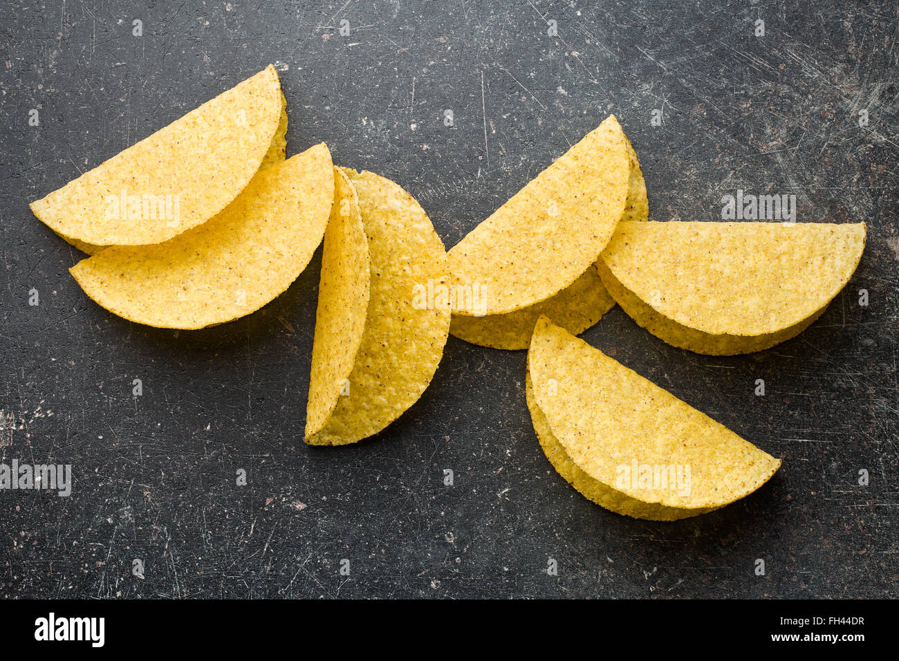 crispy taco shells on old kitchen table Stock Photo - Alamy