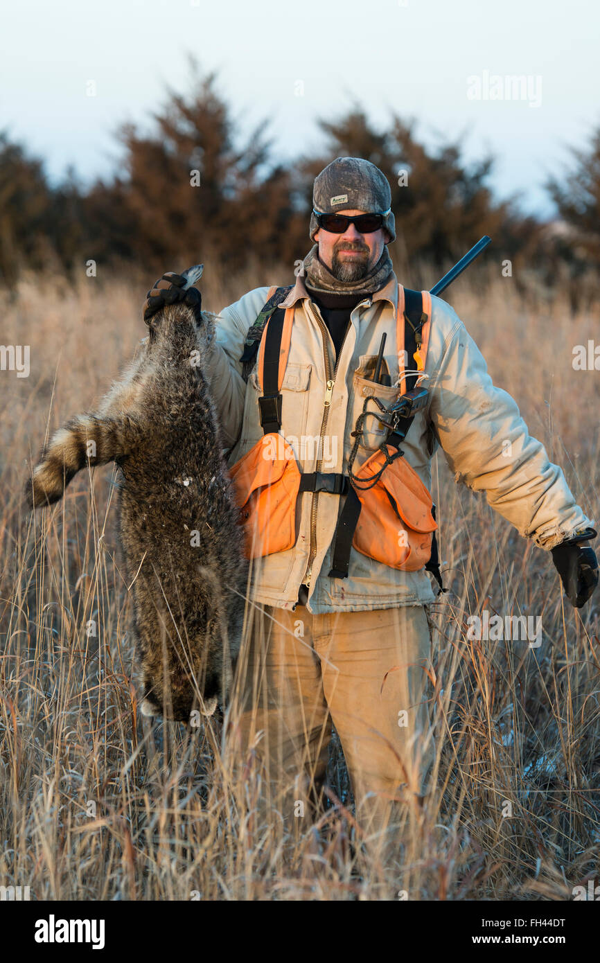 Hunter with a Raccoon Stock Photo - Alamy