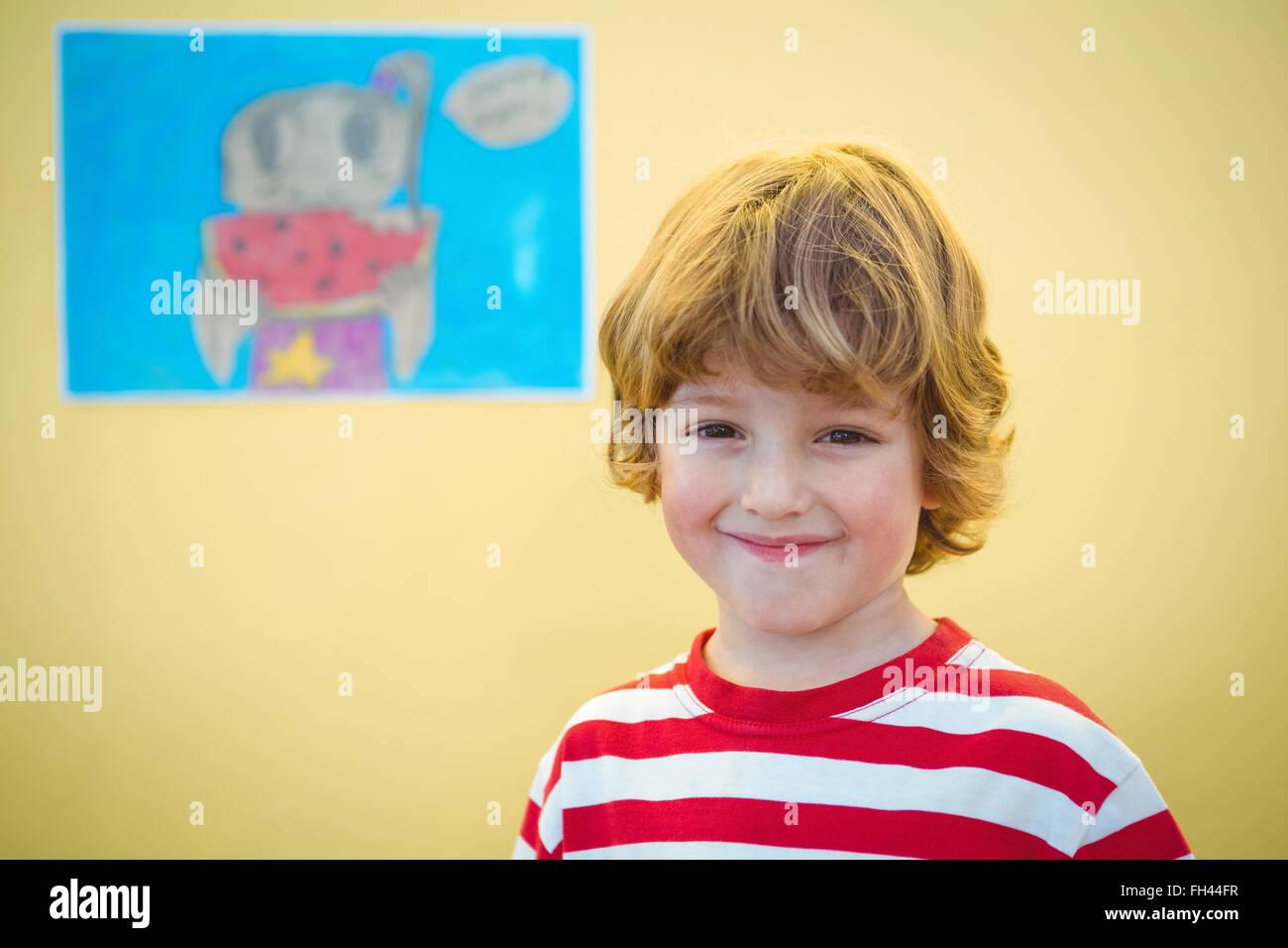Smiling boy standing in front of the camera Stock Photo - Alamy