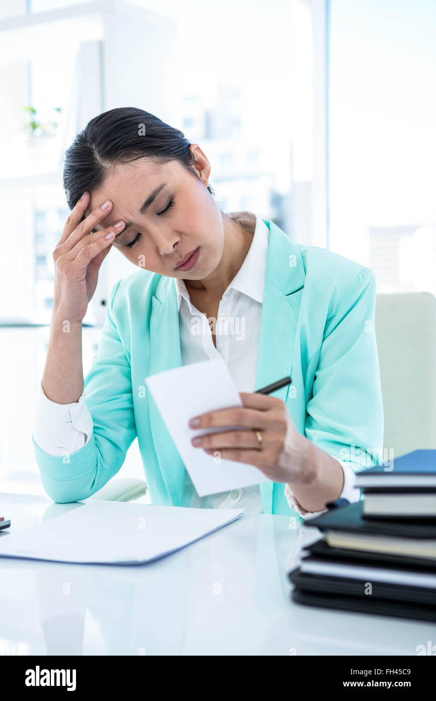 Stressed businesswoman sitting with notes Stock Photo - Alamy