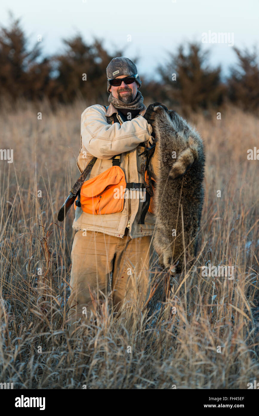Hunter with a Raccoon Stock Photo - Alamy