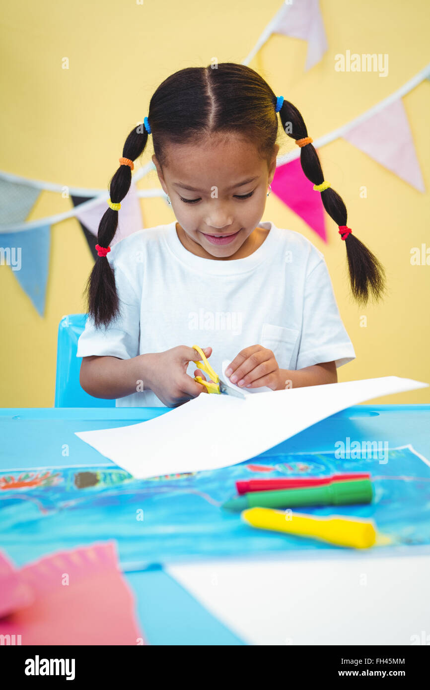 Smiling firl cutting some paper Stock Photo - Alamy