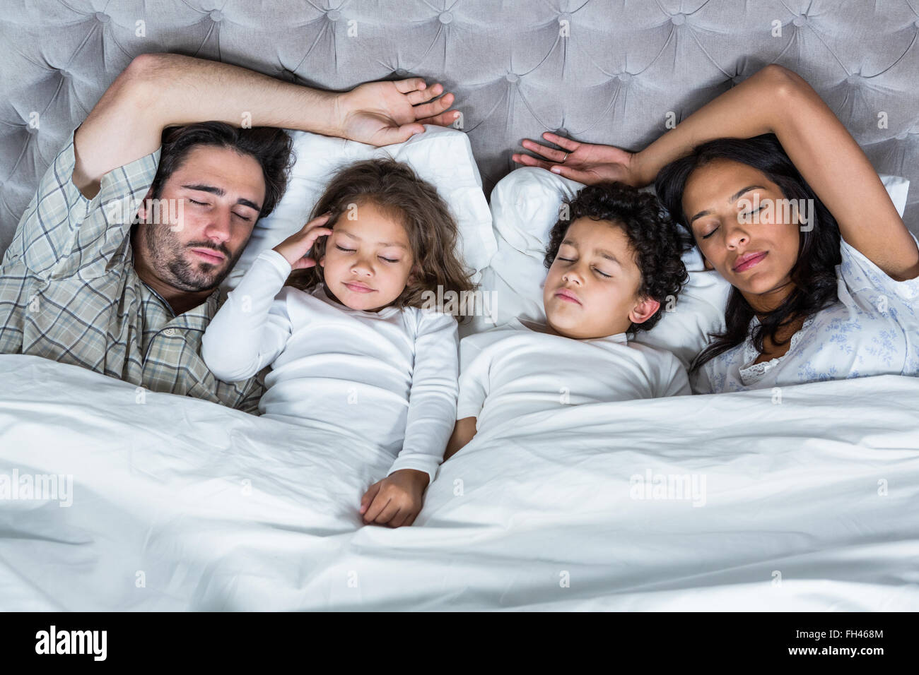 Happy family sleeping together Stock Photo - Alamy