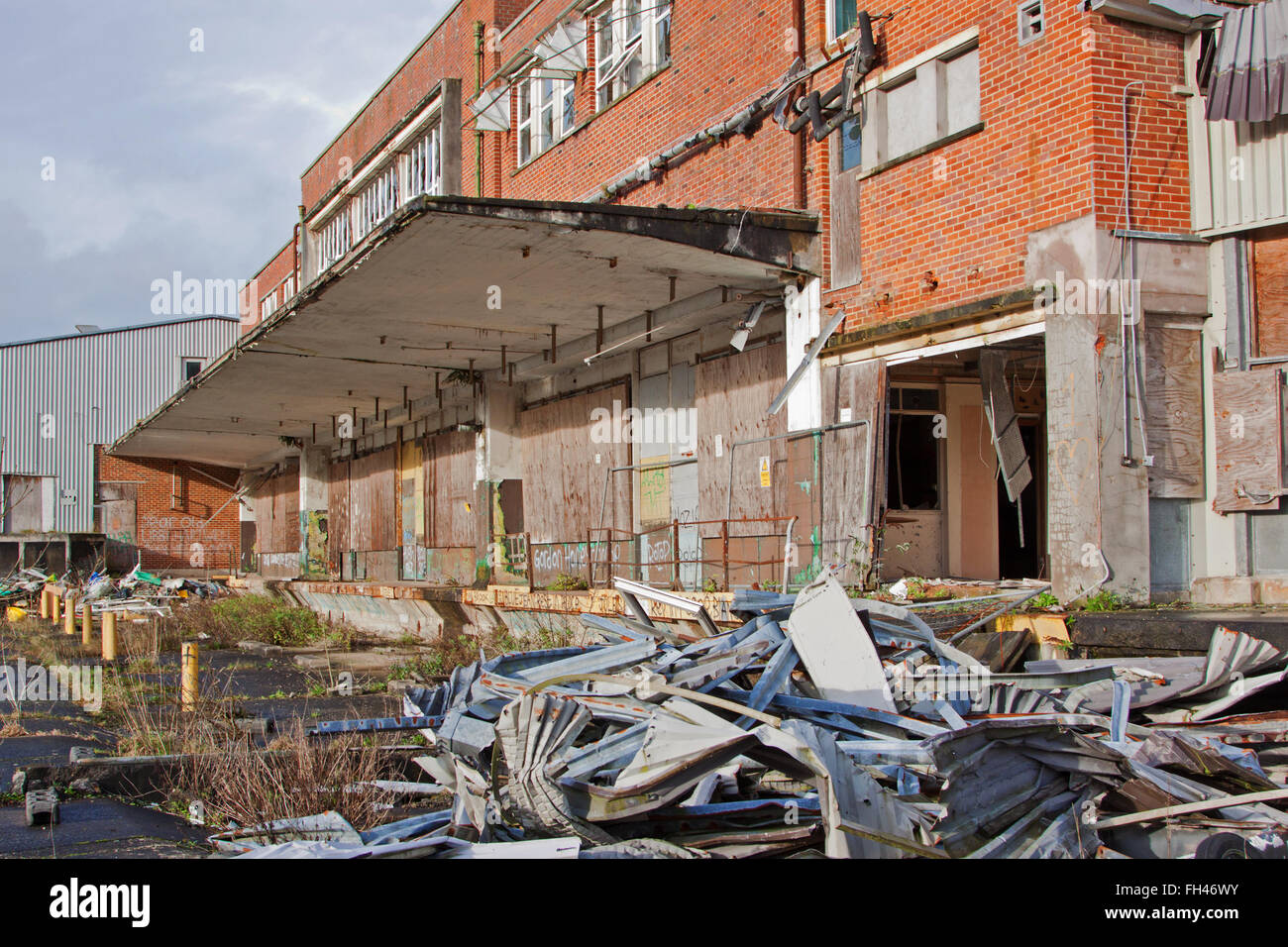 A boarded up abandoned industrial premises in UK littered with rubble ...