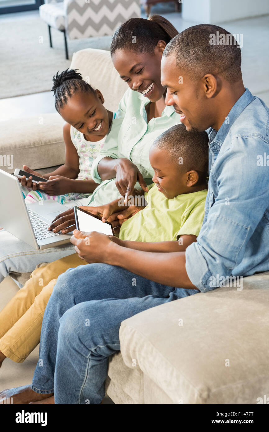 Happy family using technology together Stock Photo - Alamy