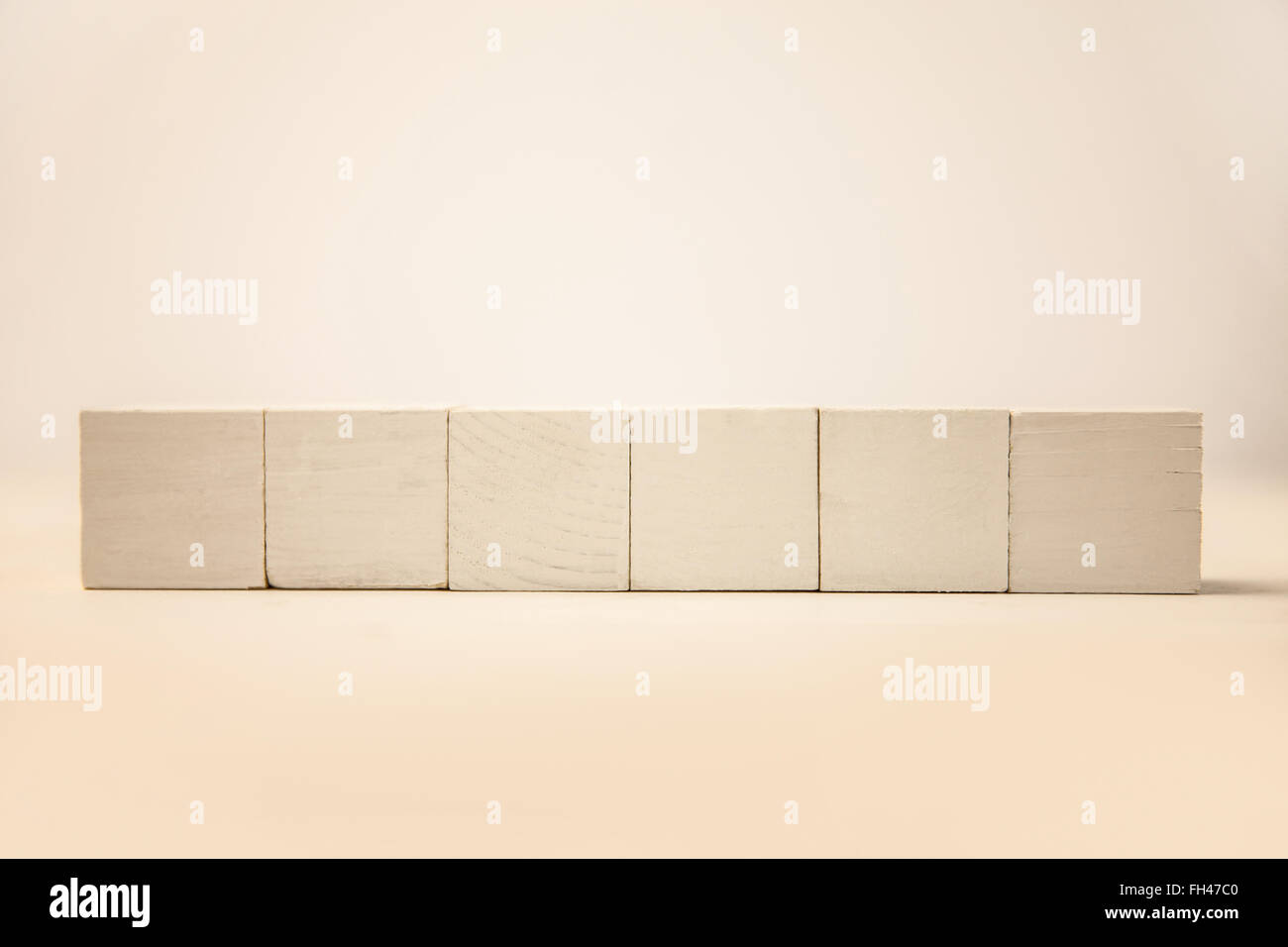 Row of blocks on table Stock Photo - Alamy