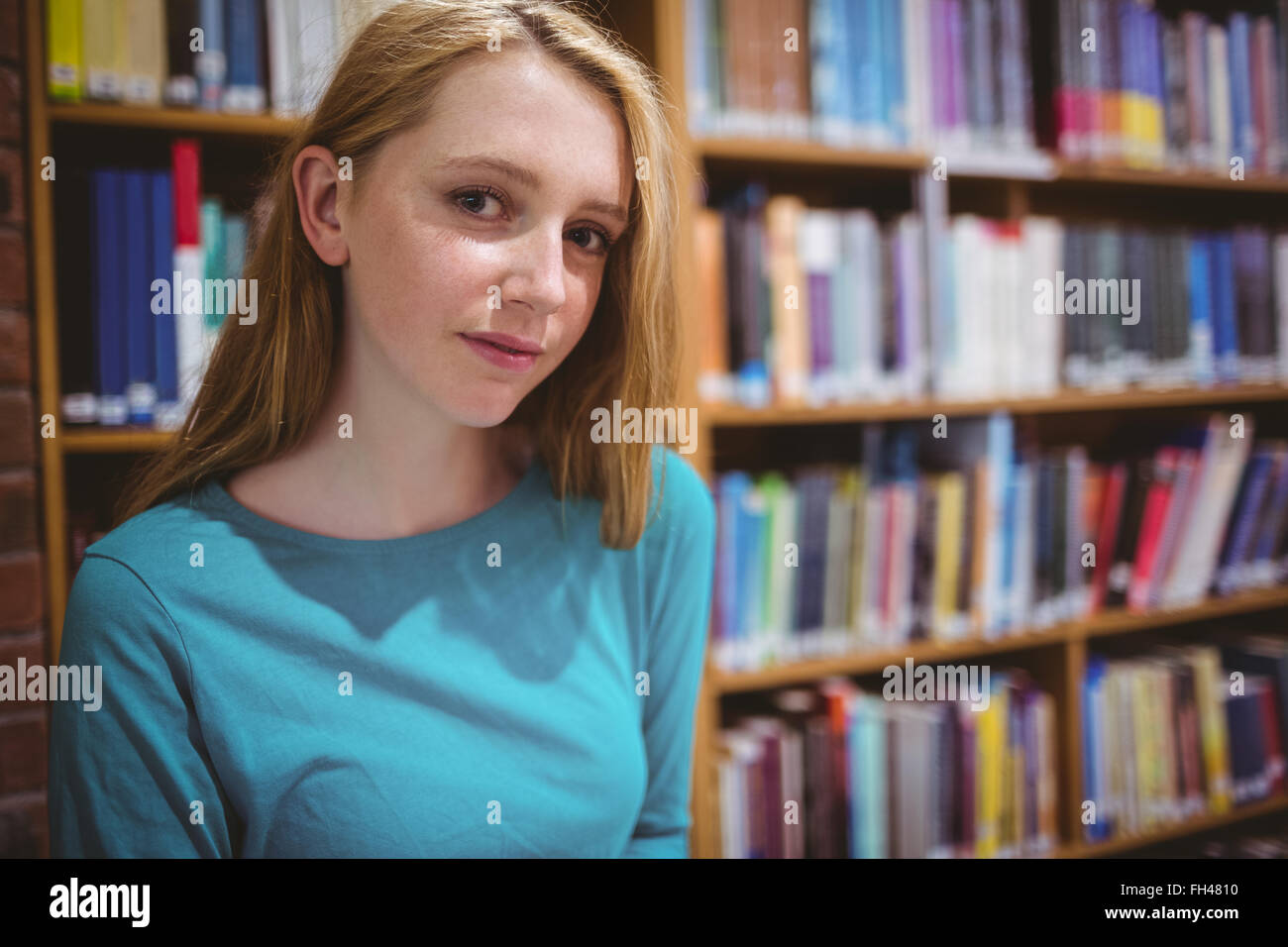 Blond student in library looking at the camera Stock Photo - Alamy