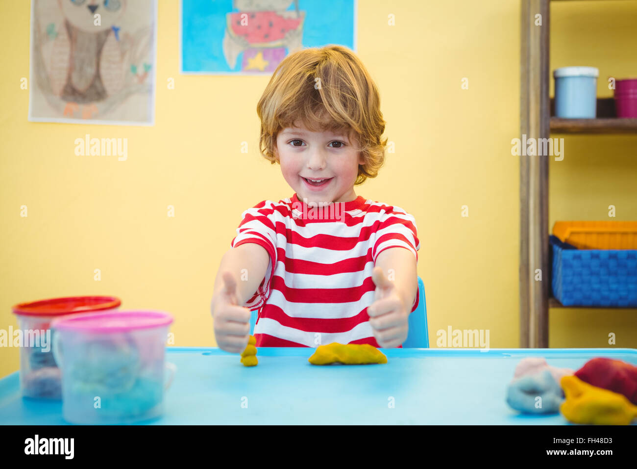 Happy boy with modelling clay Stock Photo - Alamy