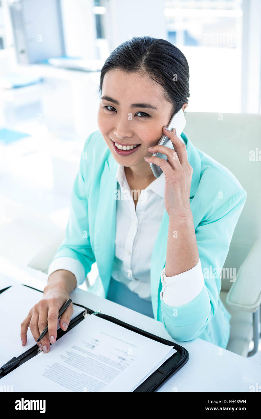 Smiling businesswoman taking notes Stock Photo - Alamy