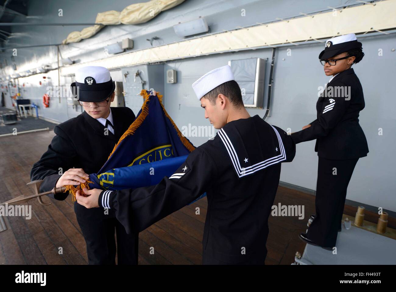 Sailors aboard the USS Mount Whitney secure the command pennant as the ...