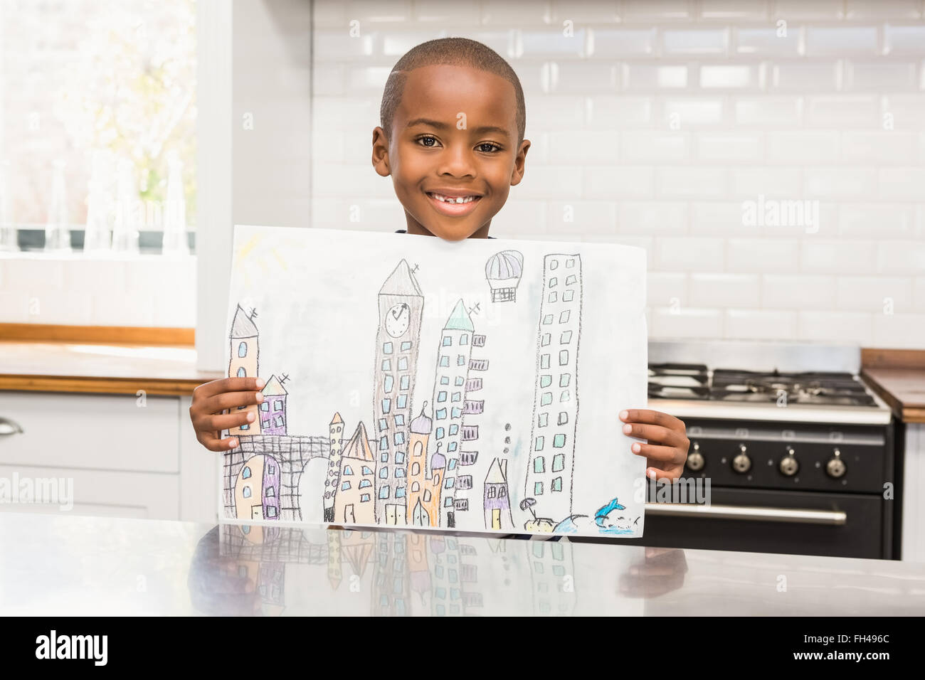 Smiling boy showing his drawing Stock Photo - Alamy