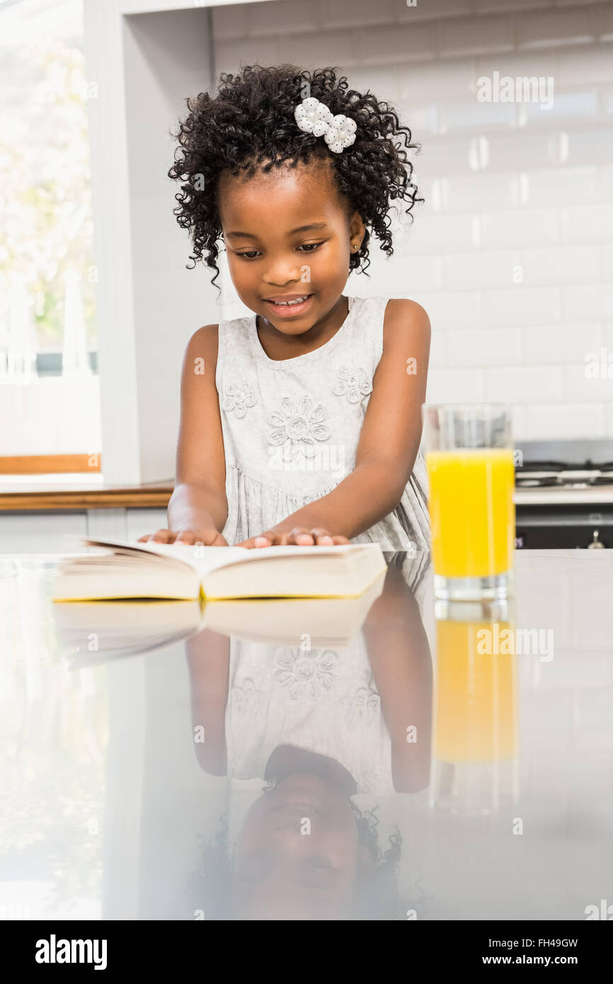 Smiling girl reading a book Stock Photo - Alamy