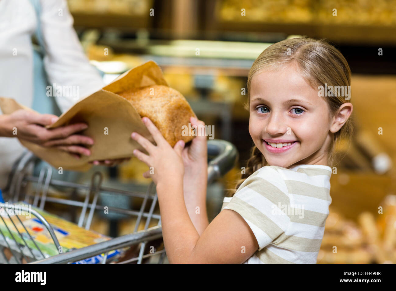 Daughter taking bread from paper bag Stock Photo - Alamy