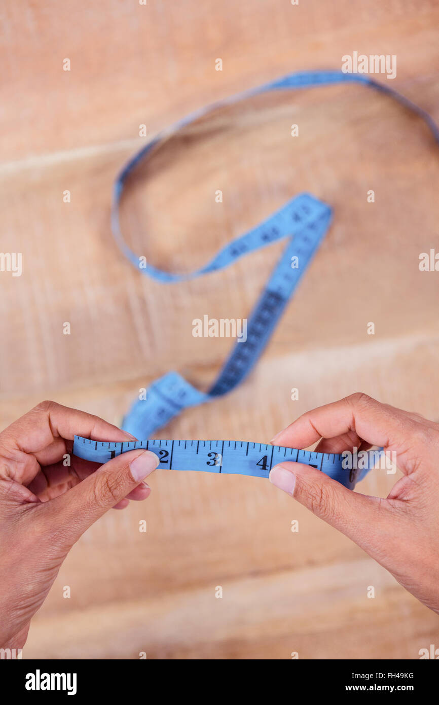 Woman holding measuring tape Stock Photo - Alamy