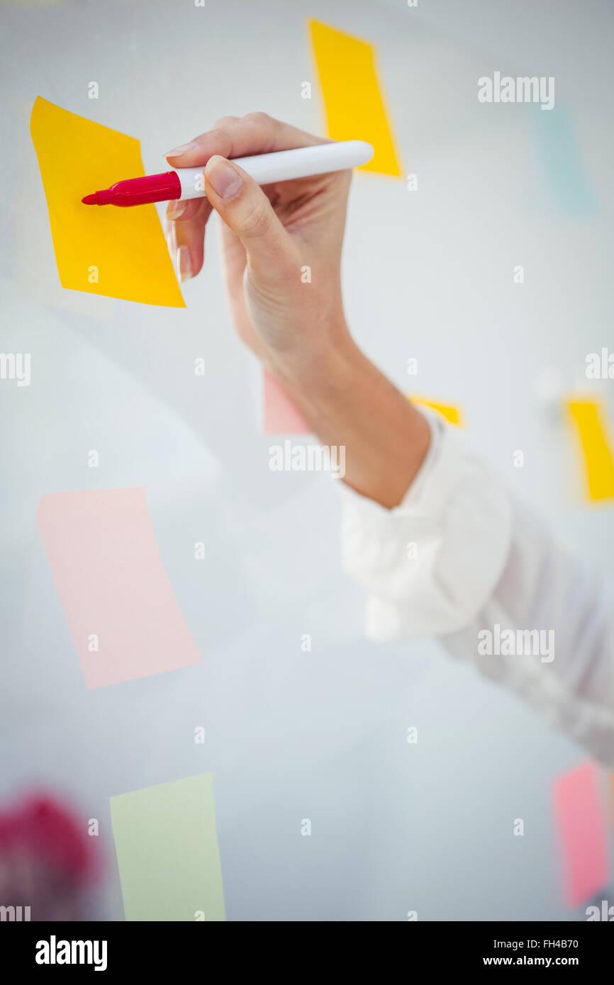 View of cropped hand writing on sticky note Stock Photo - Alamy