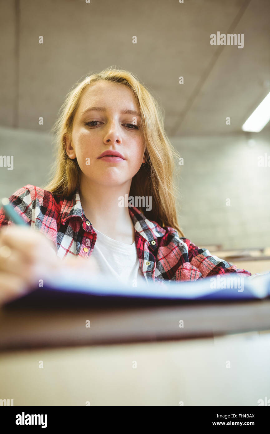 Focused student taking notes during class Stock Photo - Alamy