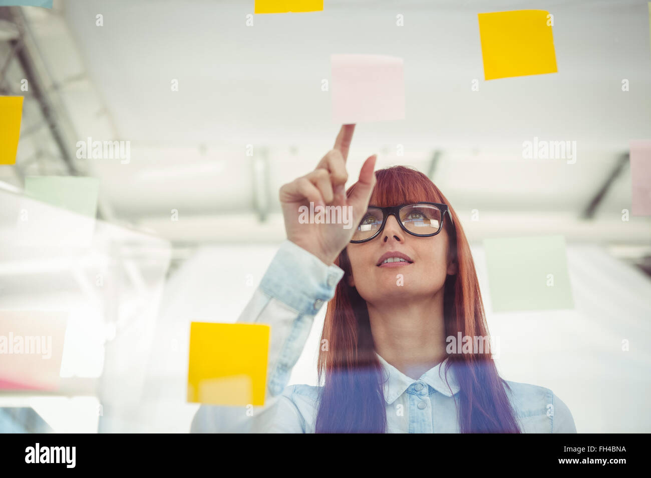 Attractive hipster woman pointing sticky notes Stock Photo - Alamy