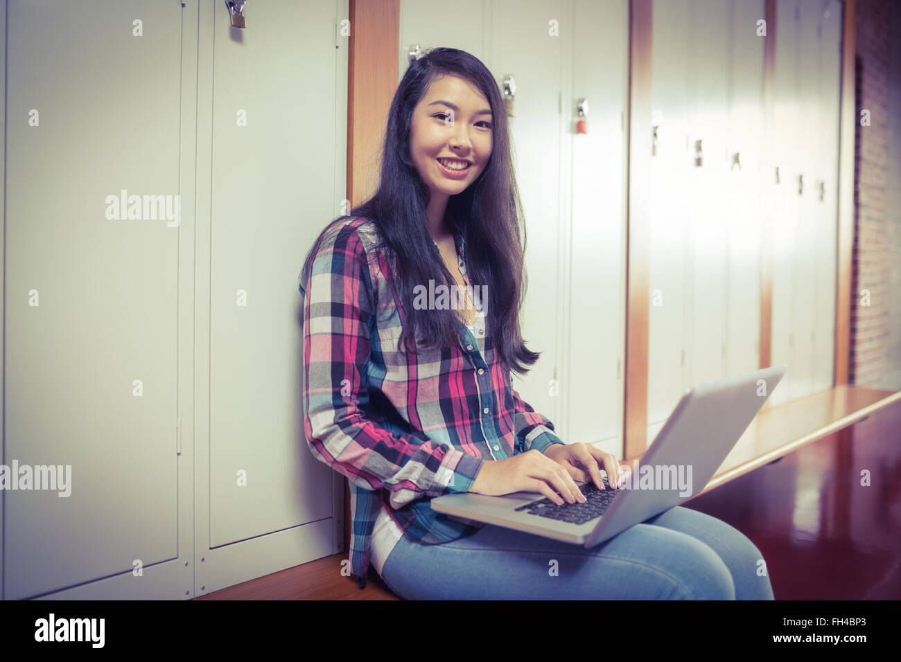 Smiling student sitting at the computer Stock Photo - Alamy