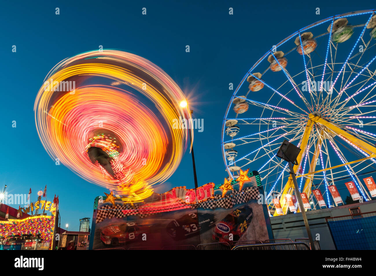 Ferris wheel and midway rides at night, Calgary Stampede Midway ...