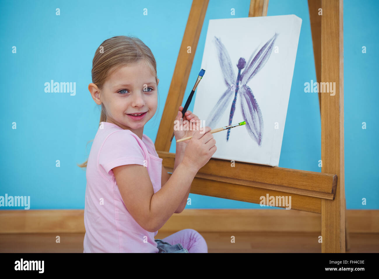 Smiling girl beside her picture Stock Photo - Alamy