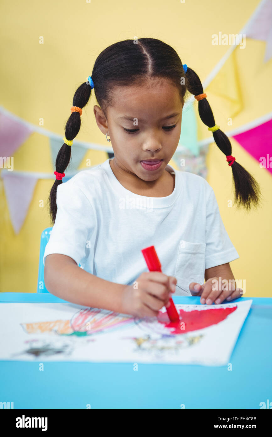 Focused girl colouring her book Stock Photo - Alamy