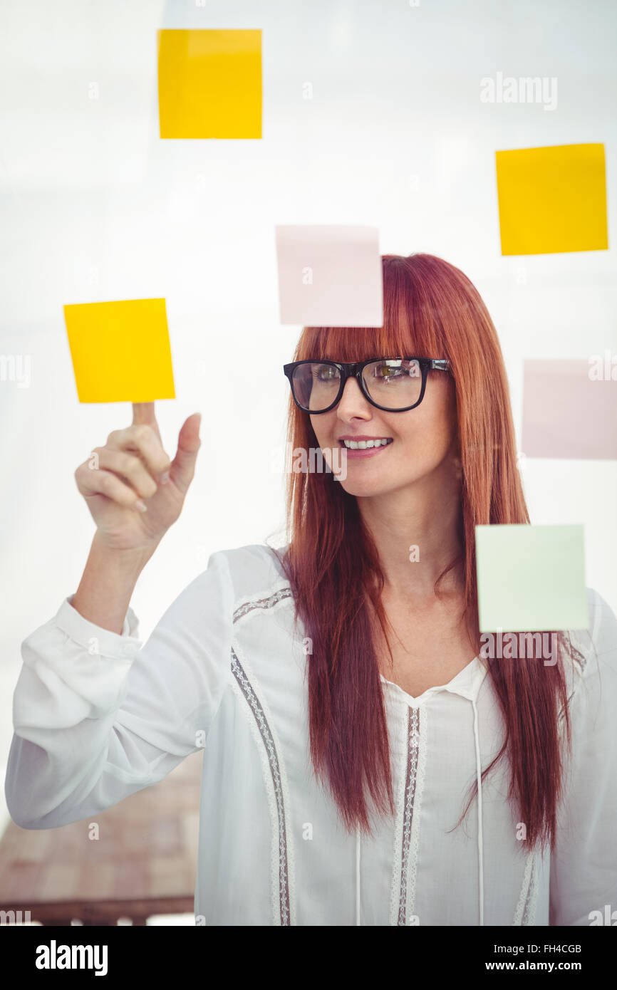 Attractive hipster woman pointing sticky notes Stock Photo - Alamy