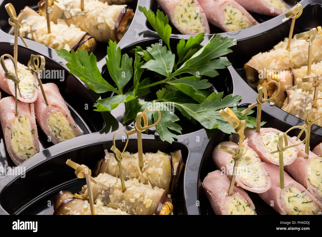 closeup set different canapes and snacks in plastic black form for ...