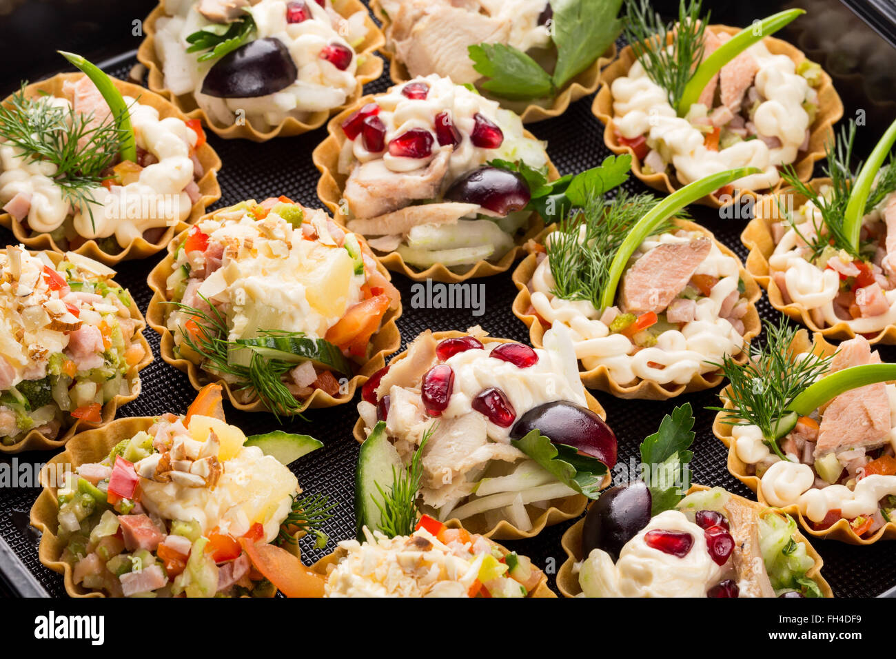 closeup set different canapes and snacks in plastic black form for ...