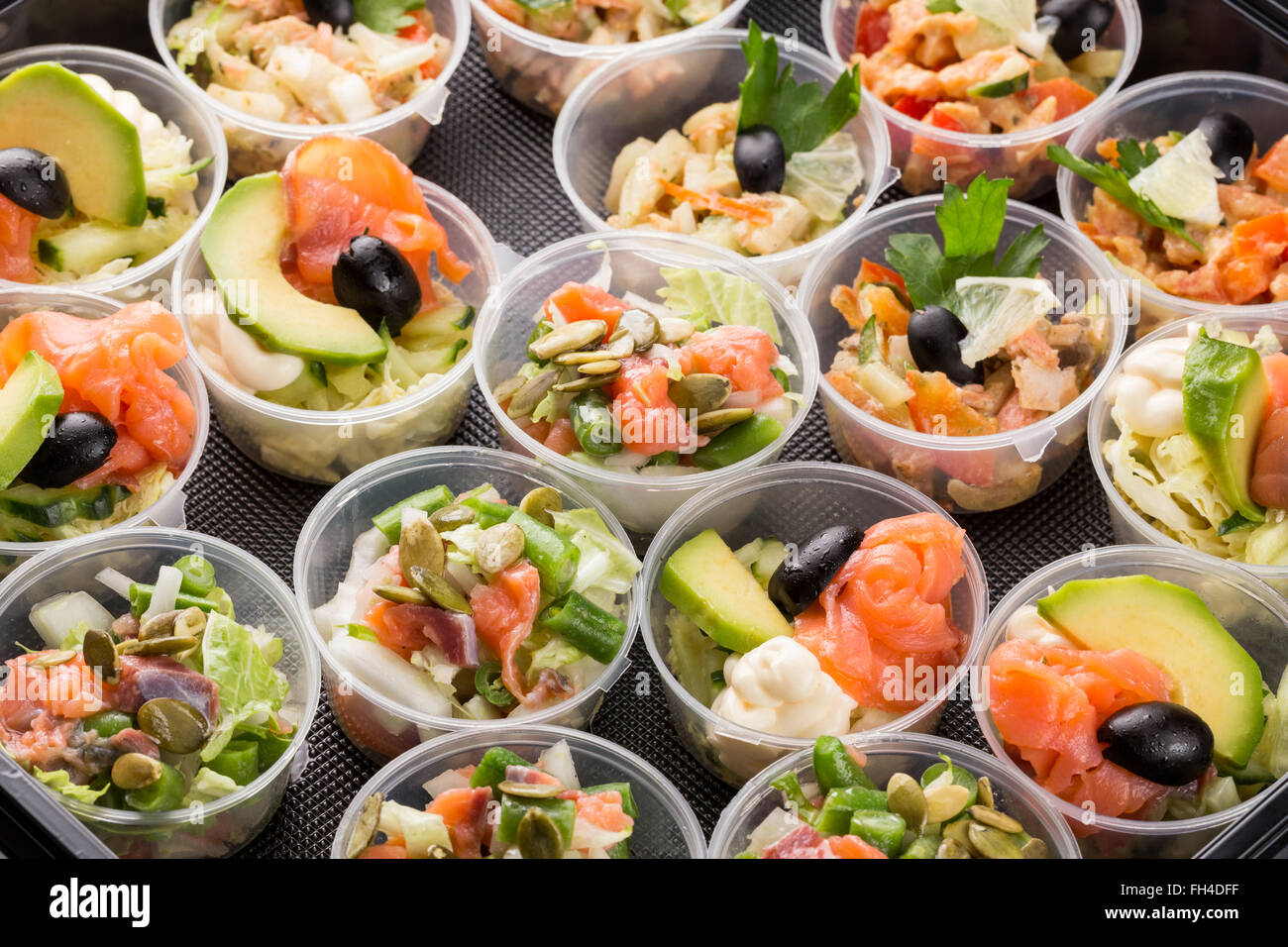 closeup set different canapes and snacks in plastic black form for ...