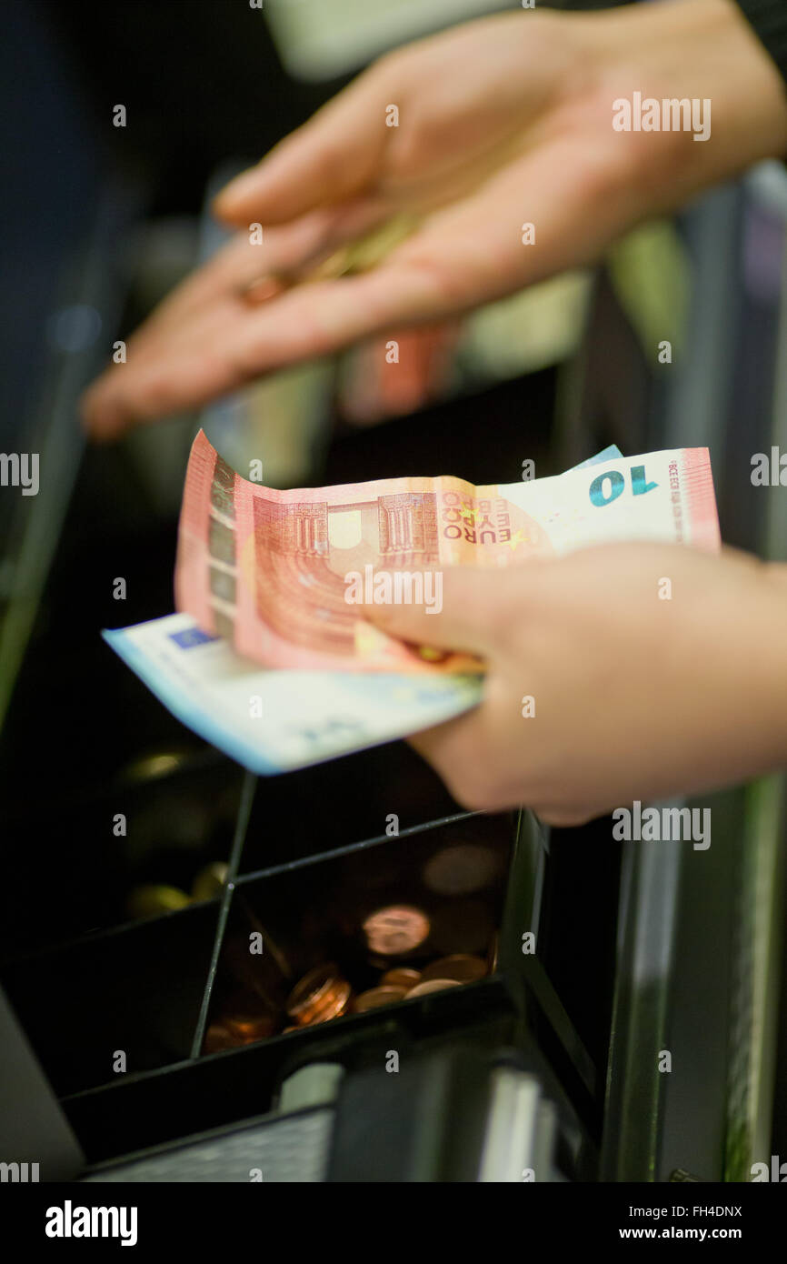 Nuremberg, Germany. 4th Feb, 2016. A cashier in a supermarket counts ...