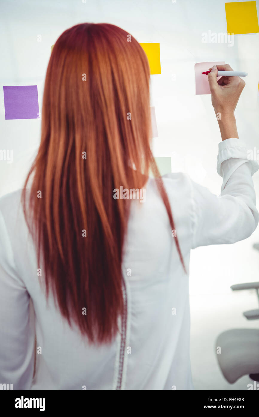Attractive hipster woman writing on sticky notes Stock Photo - Alamy