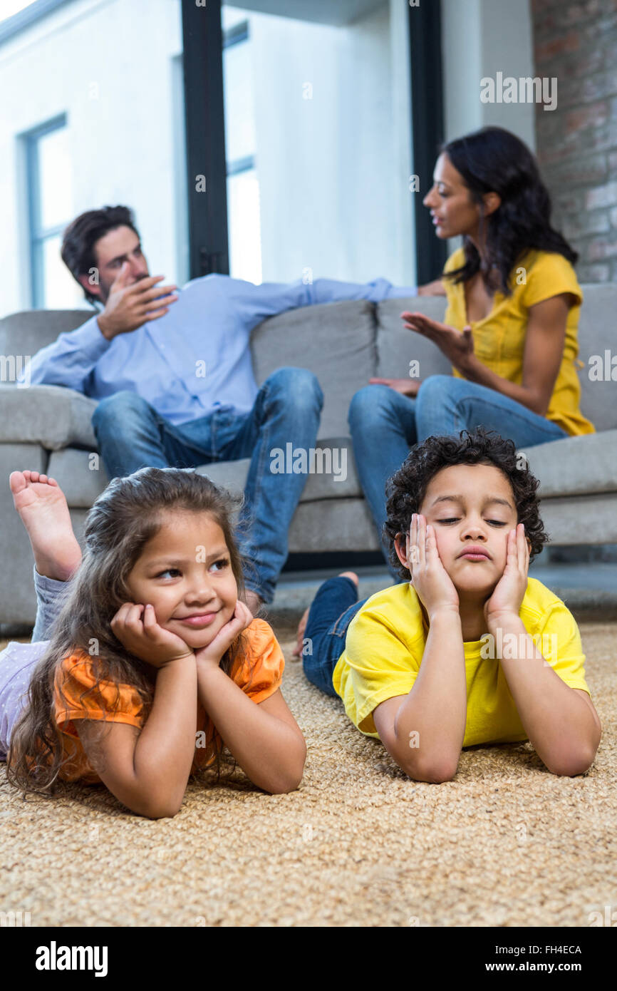 Children laying on the carpet in living room Stock Photo - Alamy