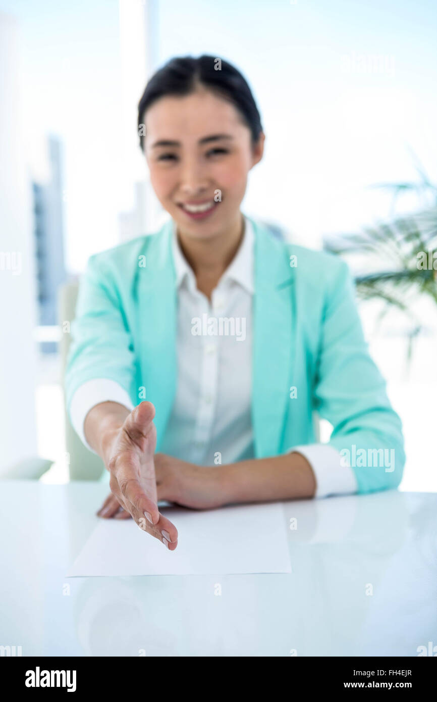 Smiling businesswoman offering a handshake Stock Photo - Alamy