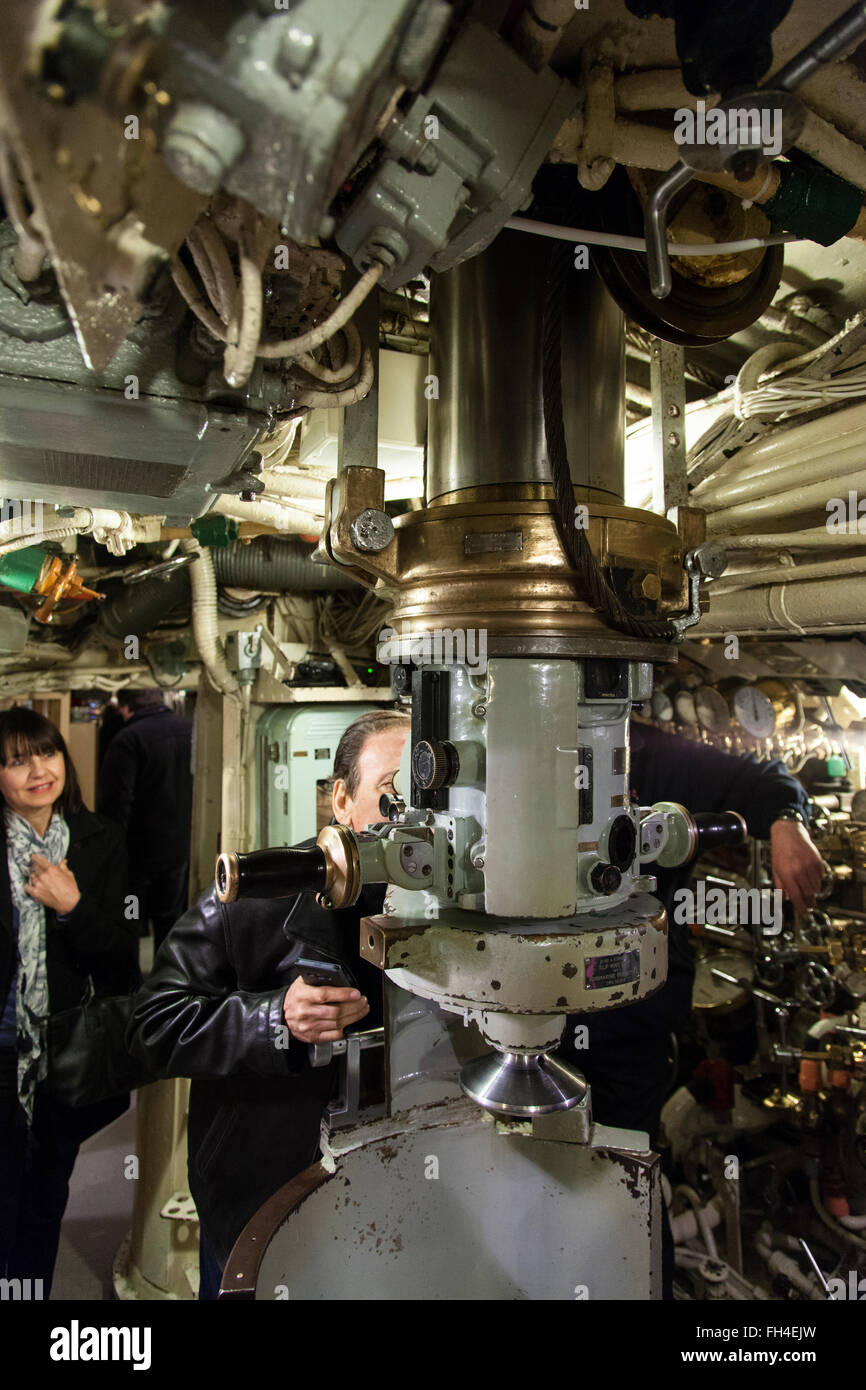 A visitor looks through the periscope on board the WWII submarine HMS ...