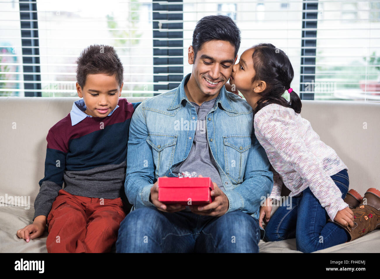 Happy father receiving a gift from his children Stock Photo - Alamy