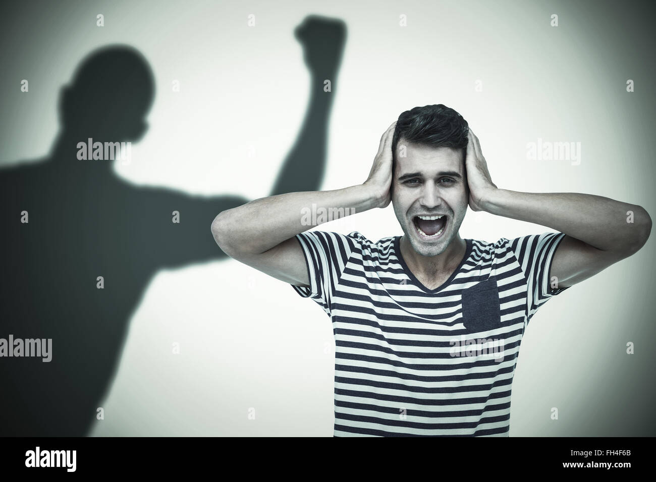 Composite image of handsome man screaming while covering ears Stock ...