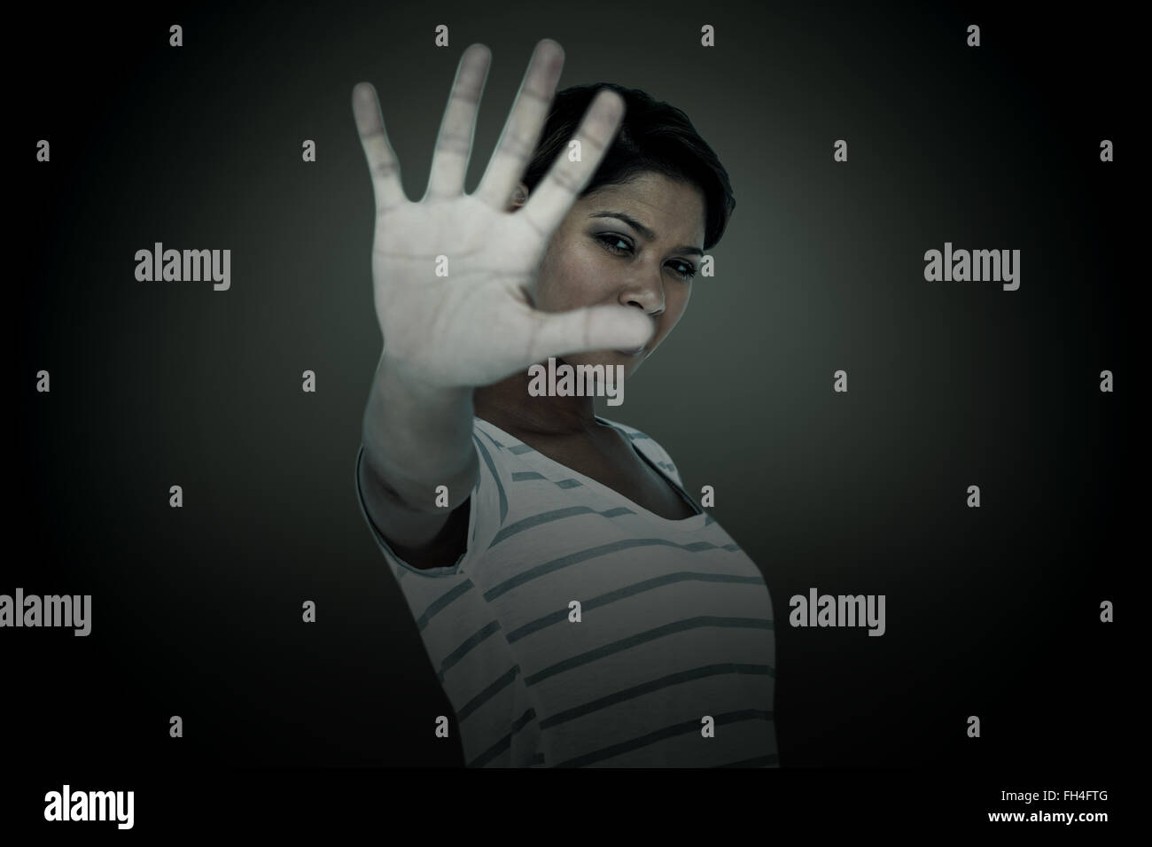 Composite image of serious woman making stop sign over white background ...