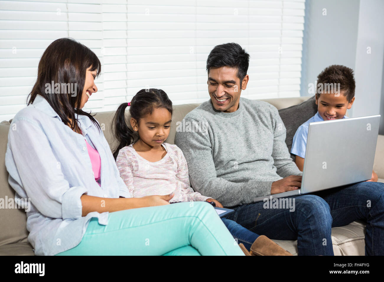 Indian parents children home laptop hi-res stock photography and images ...