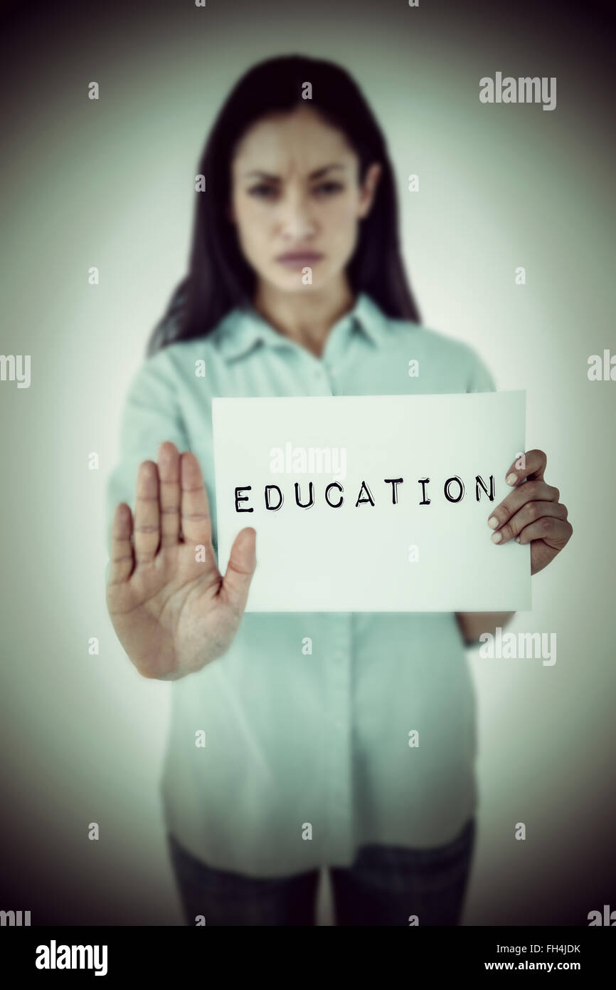 Composite image of woman showing card and saying stop Stock Photo - Alamy