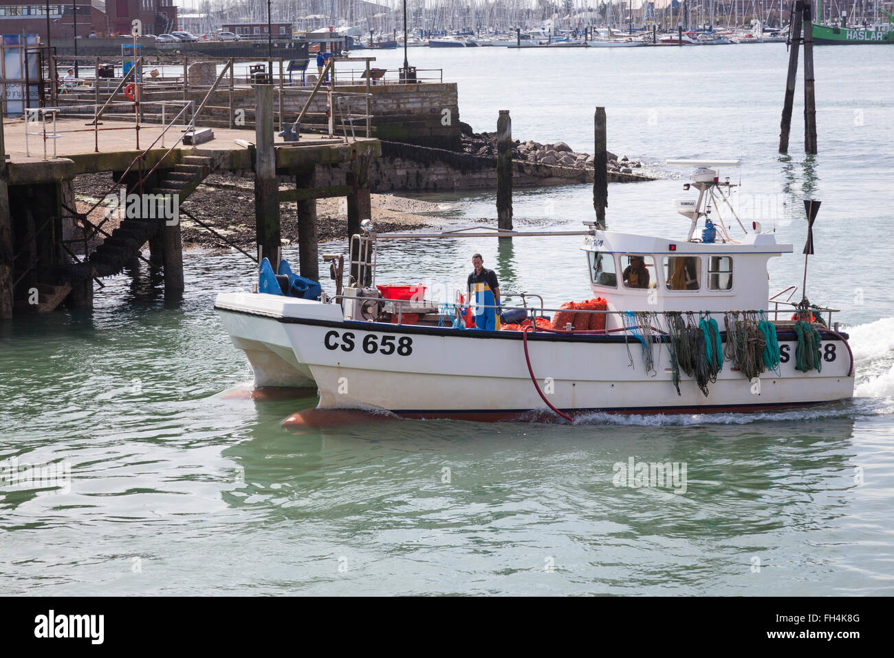 A catamaran fishing boat prepares to enter the Camber Dock, Portsmouth ...