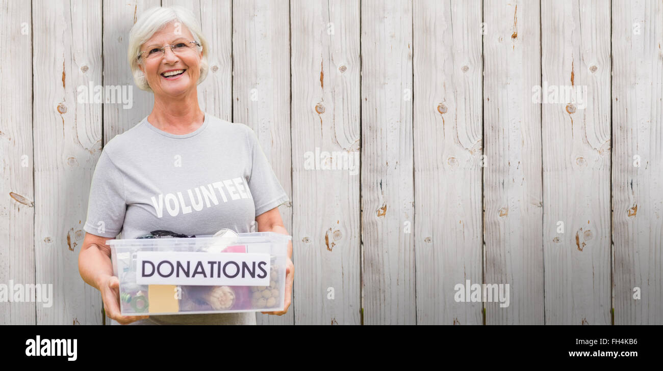 Composite image of happy grandmother holding donation box Stock Photo ...