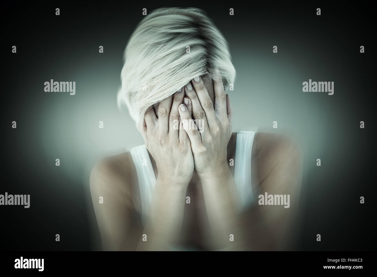 Composite image of sad blonde woman crying with head on hands Stock ...