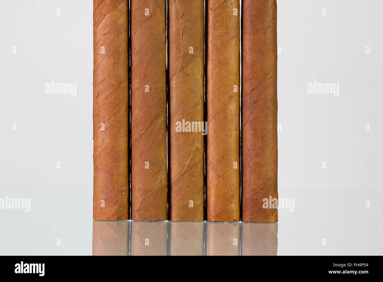 Different cigars on a glass table and white background Stock Photo - Alamy