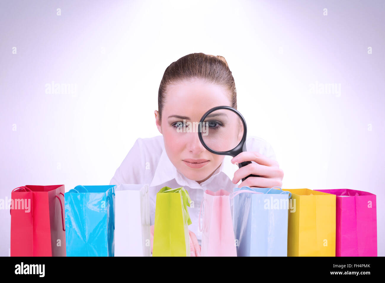 Composite image of businesswoman typing and looking through magnifying ...
