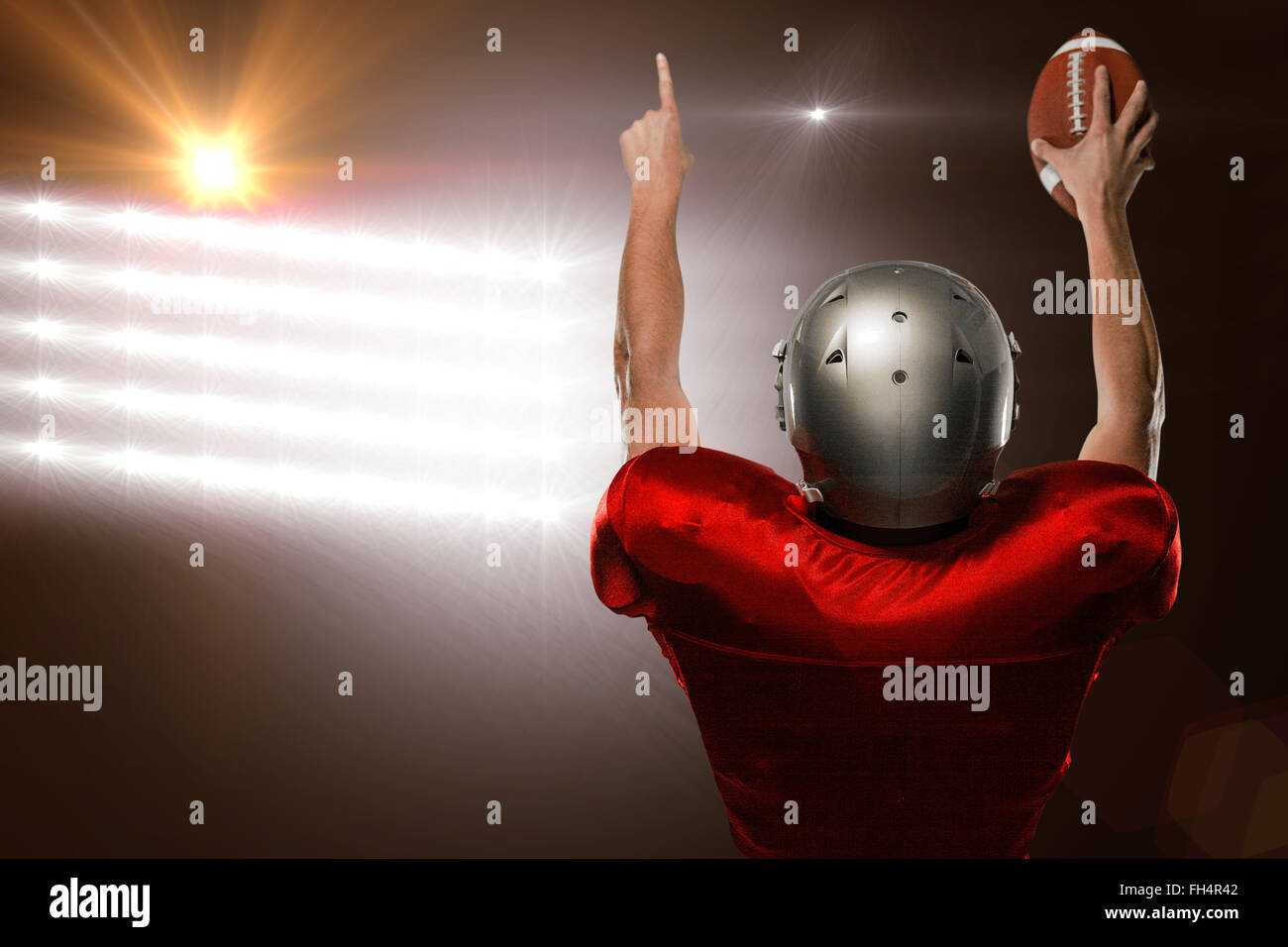 Composite image of rear view of american football player with arms ...