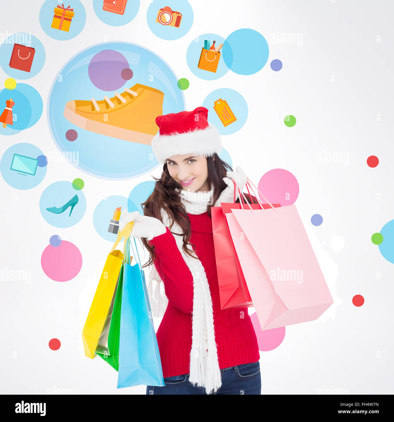 Composite image of smiling brunette in winter wear holding shopping ...