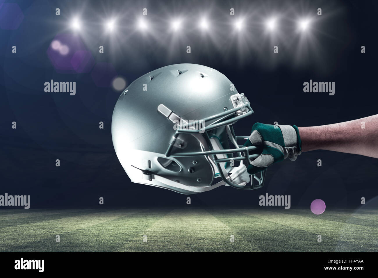 Composite image of cropped hand of sportsman holding helmet Stock Photo ...