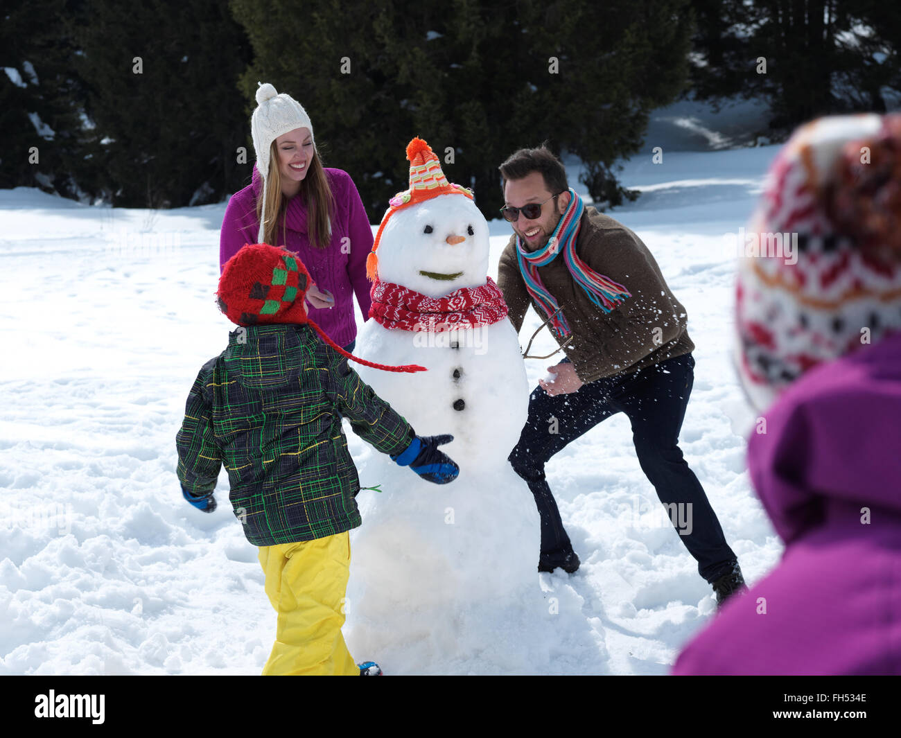 happy family making snowman Stock Photo - Alamy