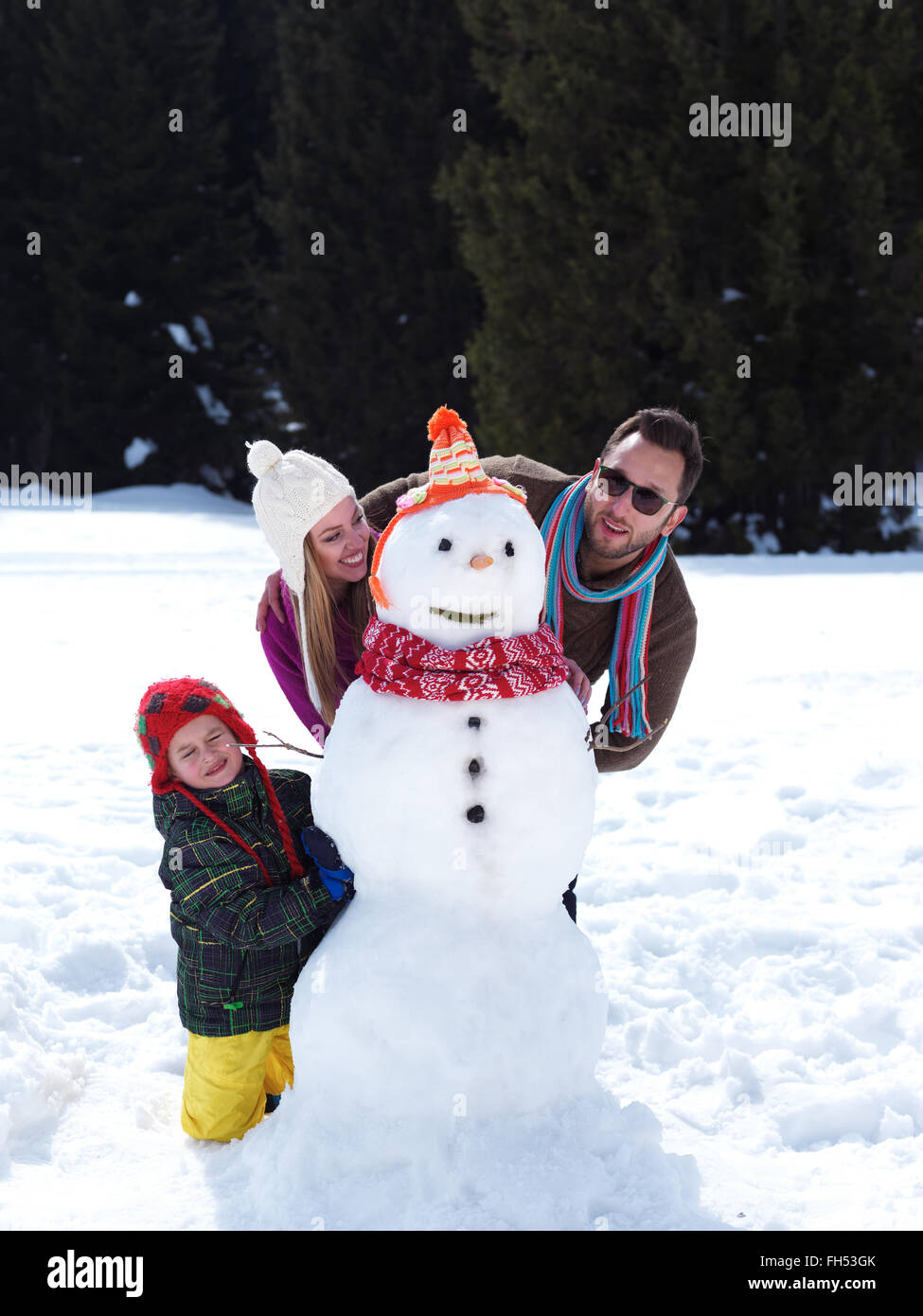 happy family making snowman Stock Photo - Alamy